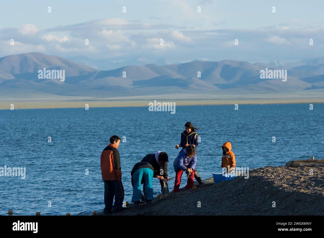 Eskimo Inupiat people kids playing at camp on a sandspit along ...