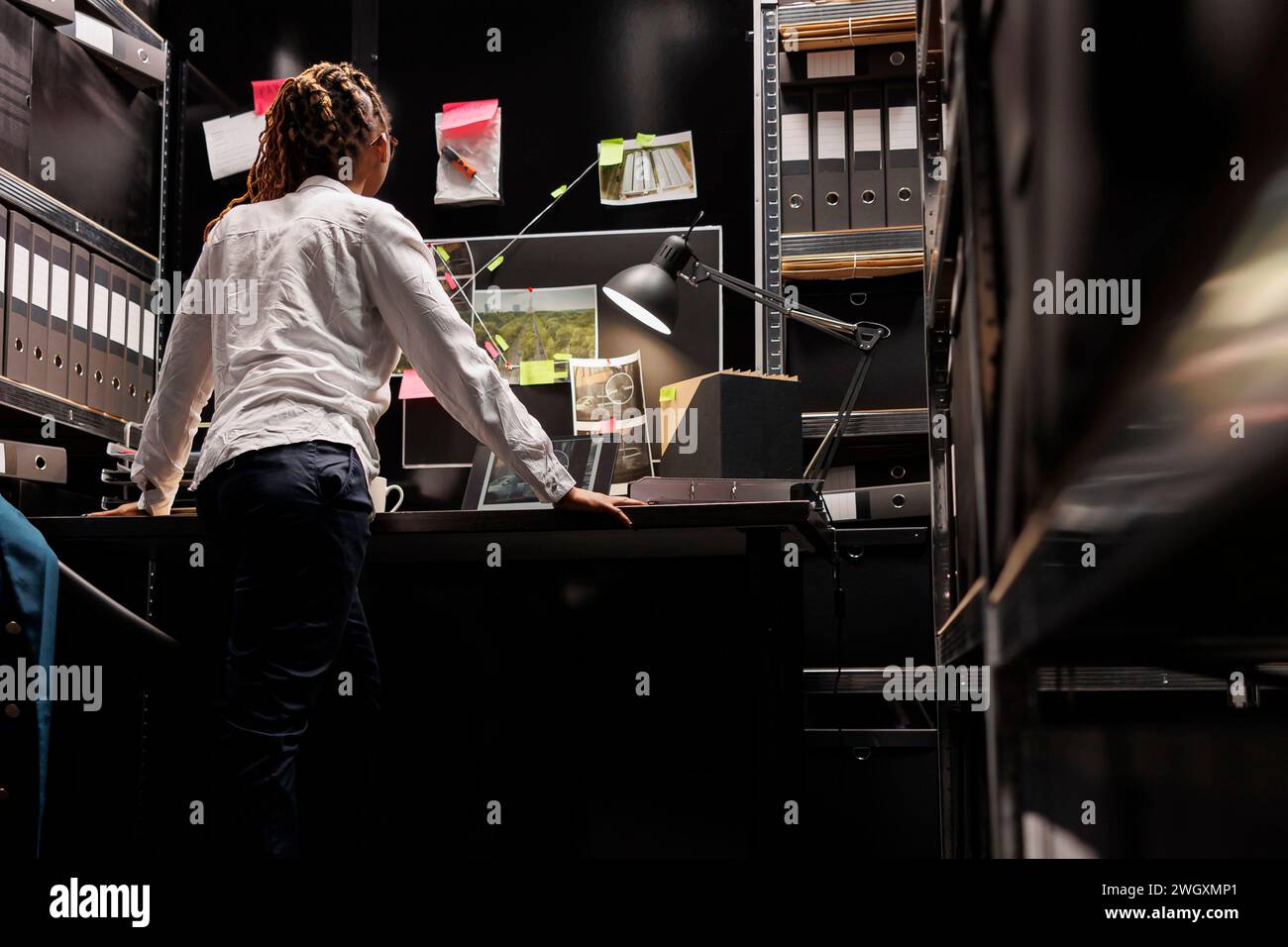 African american woman private detective looking at surveillance photos ... African american woman private detective looking at surveillance photos ...