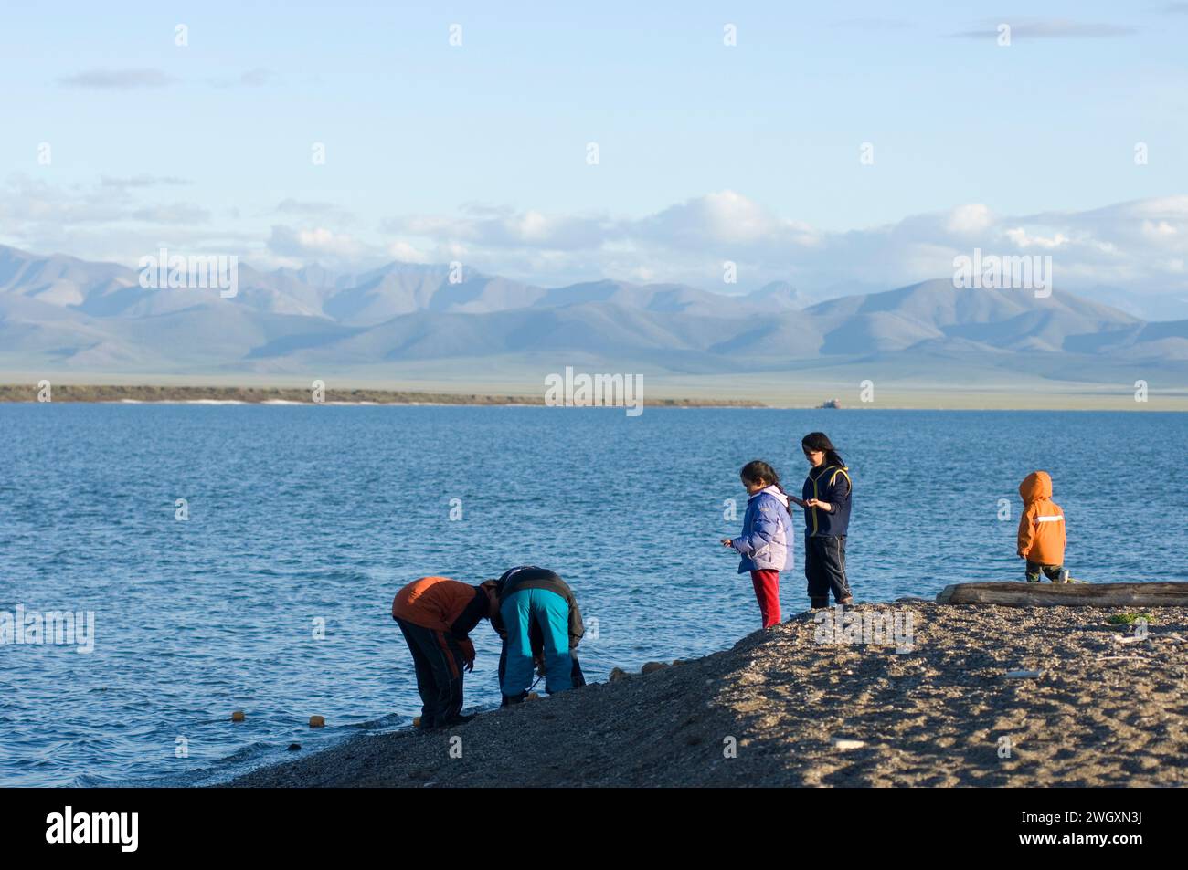 Eskimo Inupiat people kids playing at camp on a sandspit along ...