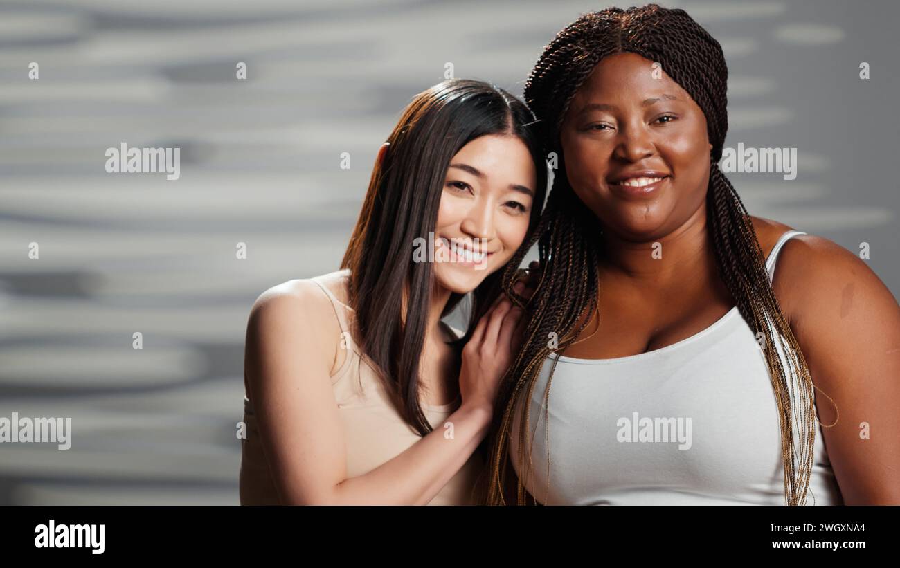 Happy Interracial Ladies Laughing At Camera And Hugging Enjoying