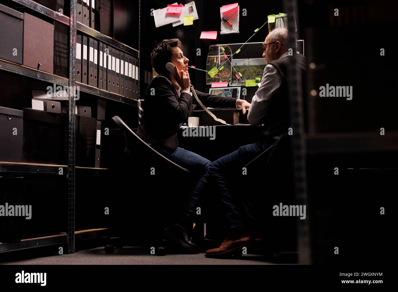 Woman police officer talking at landline phone, discussing criminology ...