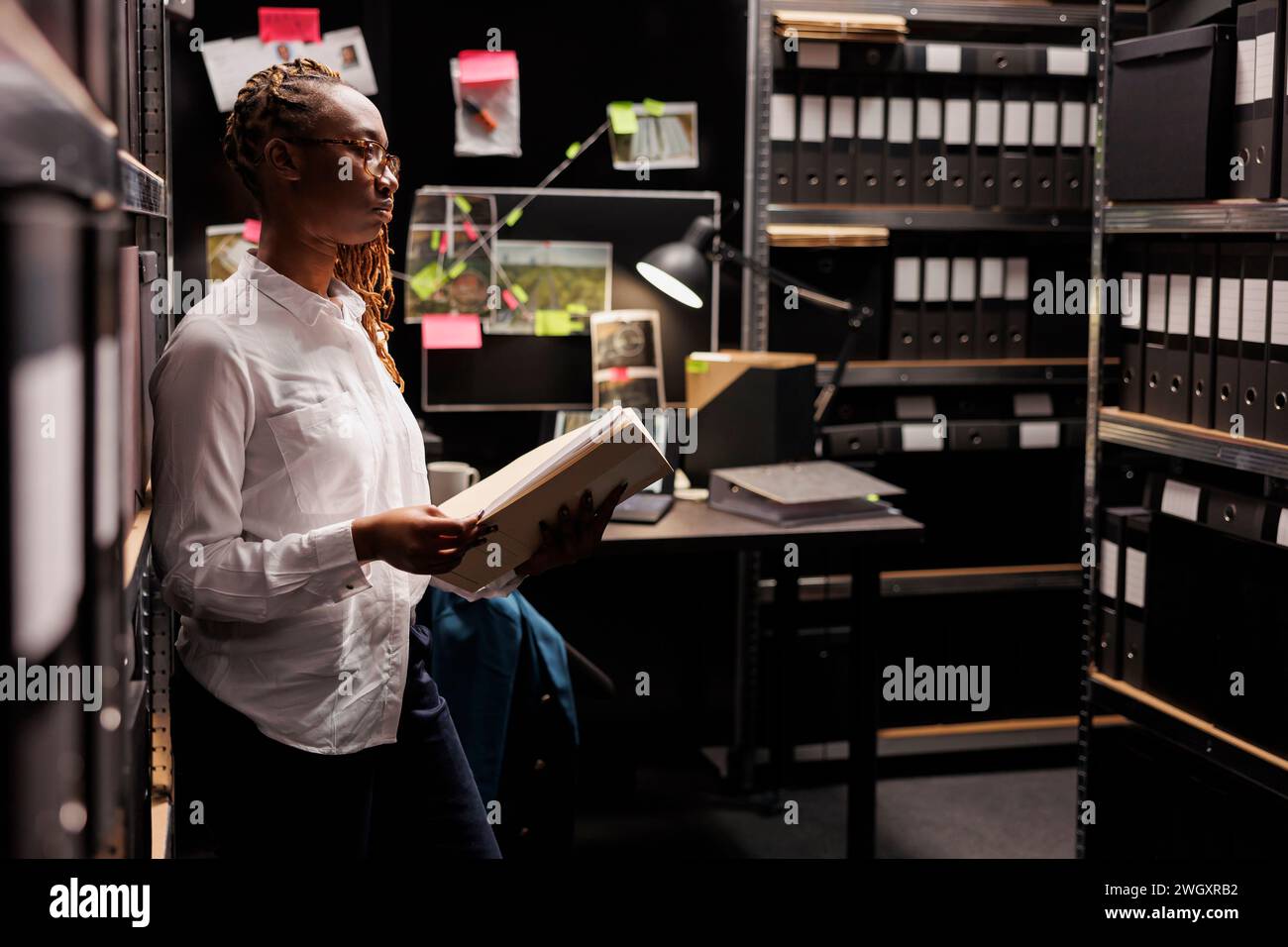 Law enforcement professional reading investigation materials in ...