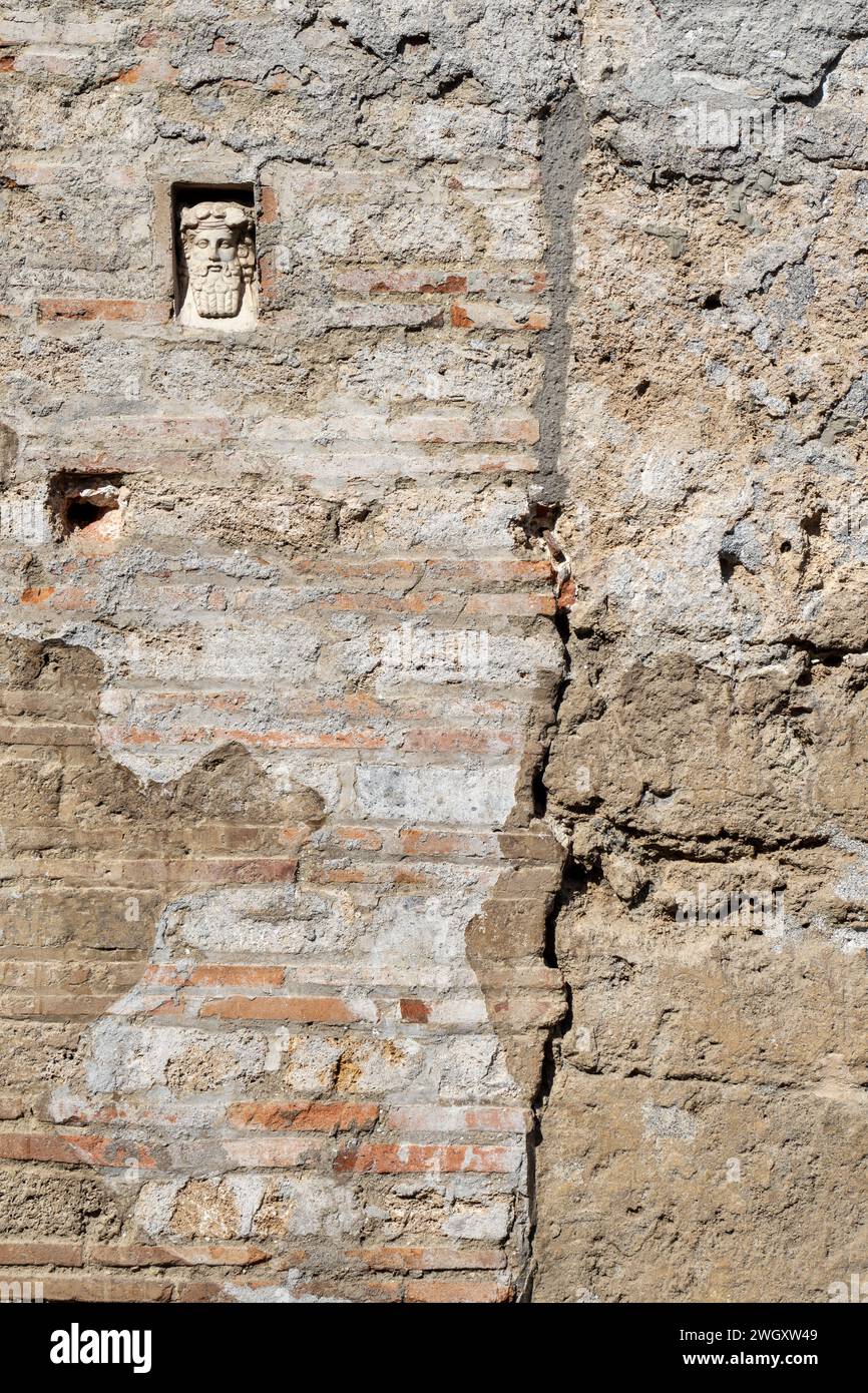 statue on the wall of human representation in the archeological park of ...