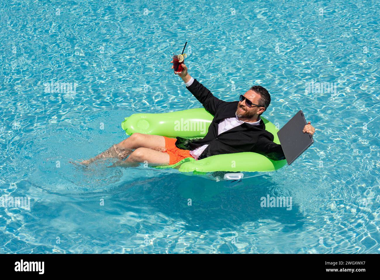 Handsome man floating in pool hi-res stock photography and images - Alamy