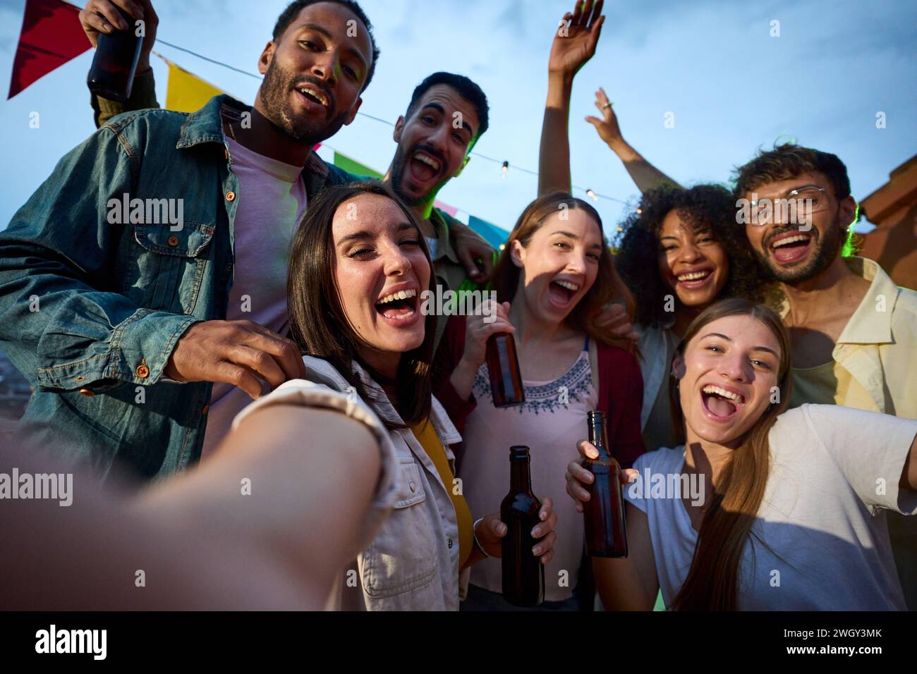 Joyful attractive young woman taking selfie at millennial alcohol party ...