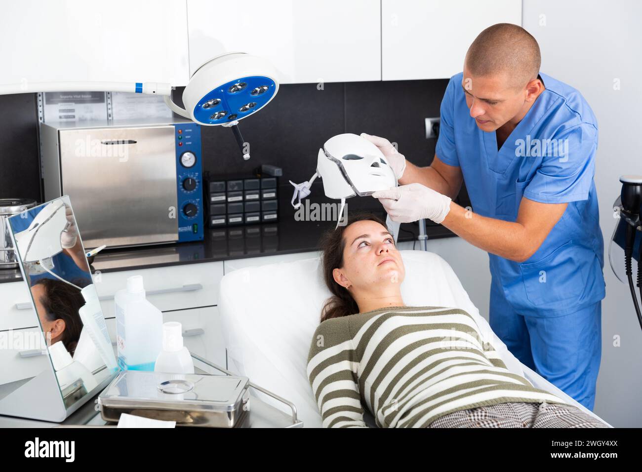 Woman receiving LED facial mask light therapy Stock Photo - Alamy
