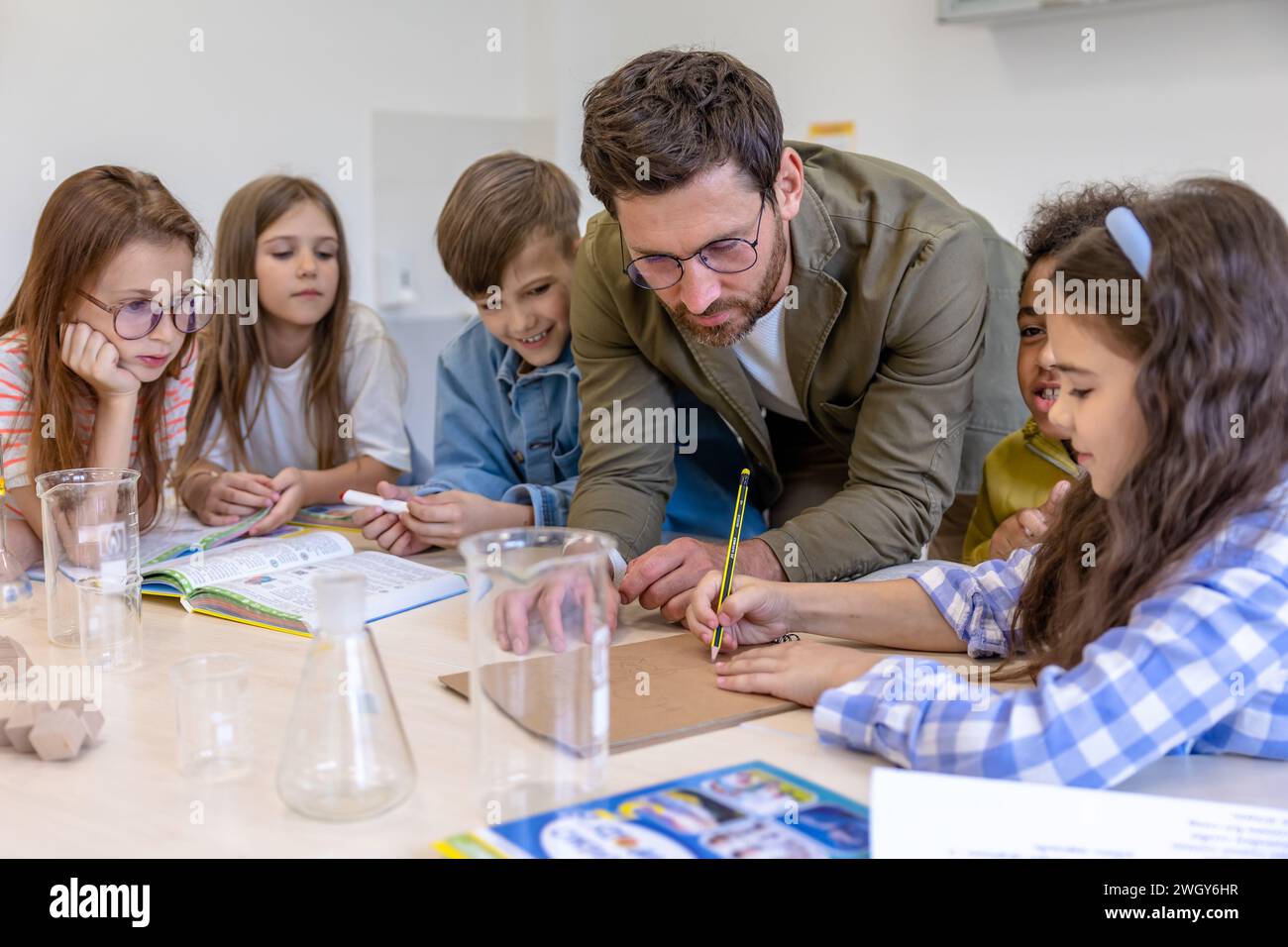Diverse kids talking teacher learning hi-res stock photography and ...