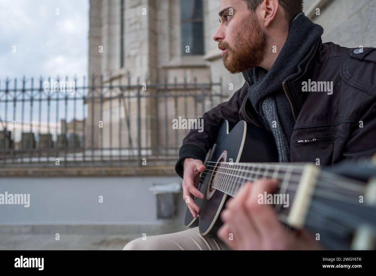 Closeup of a sad guitarist playing guitar alone. Cultural concept Stock ...