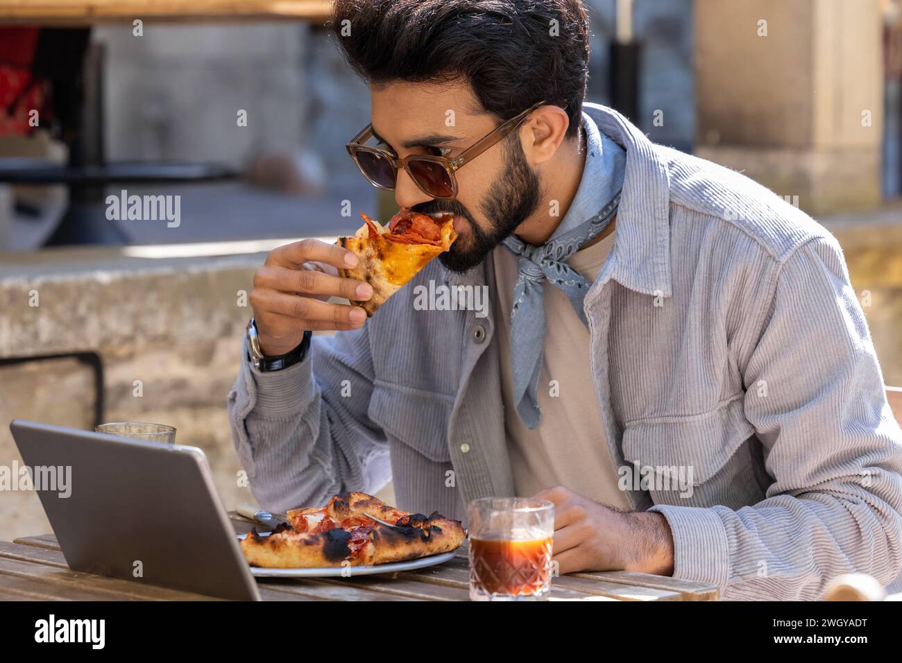 Man in a cafe eating pizza in a pizzeria Stock Photo - Alamy