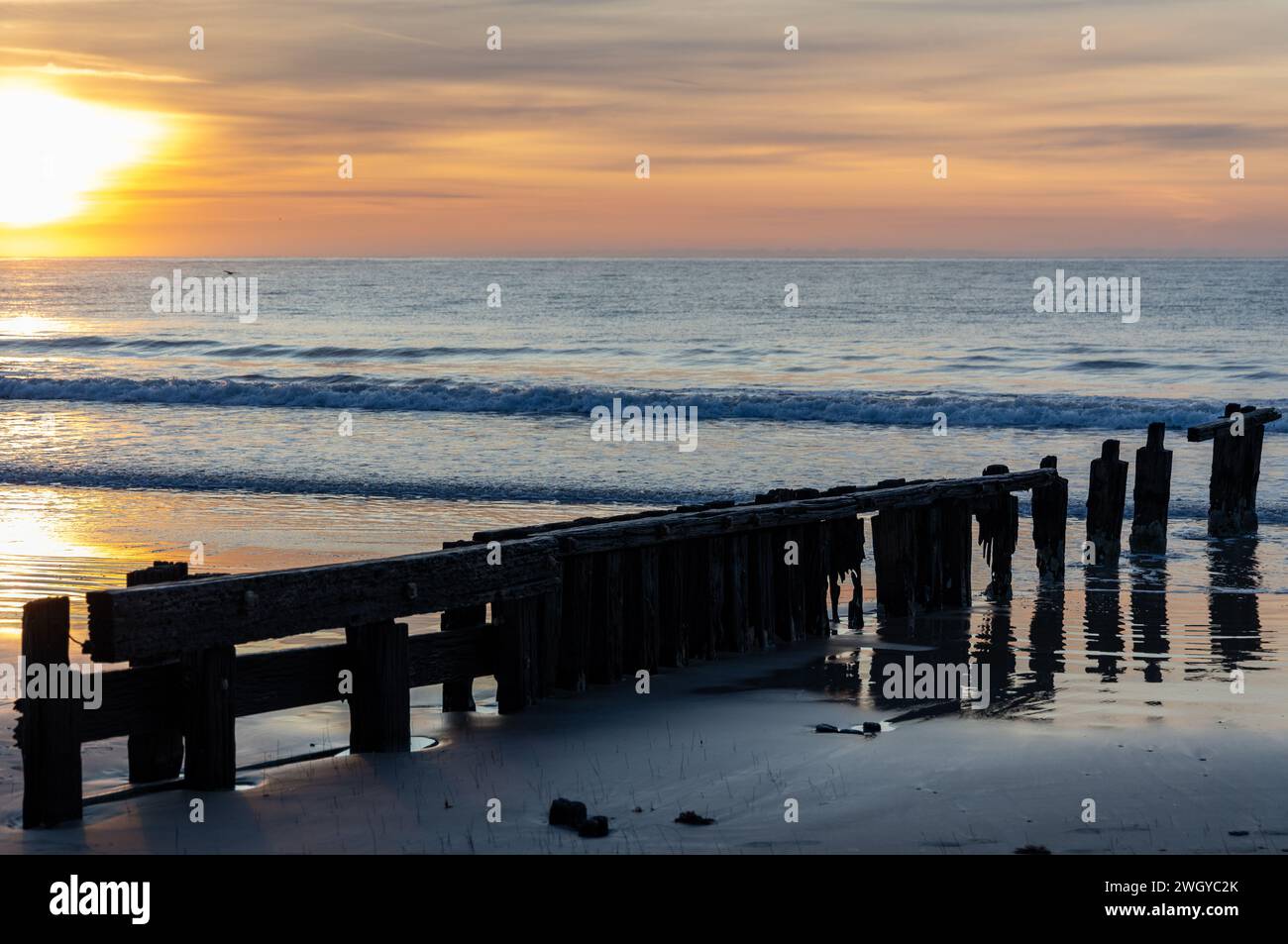 A Victor Harbor beach sunrise over the erosion groynes in South ...