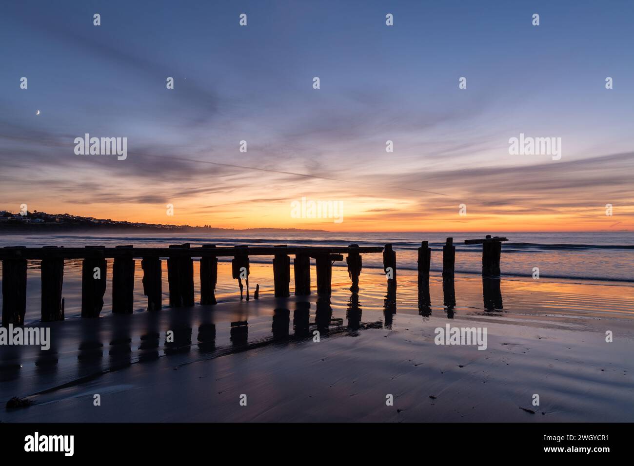 A Victor Harbor beach sunrise over the erosion groynes in South ...