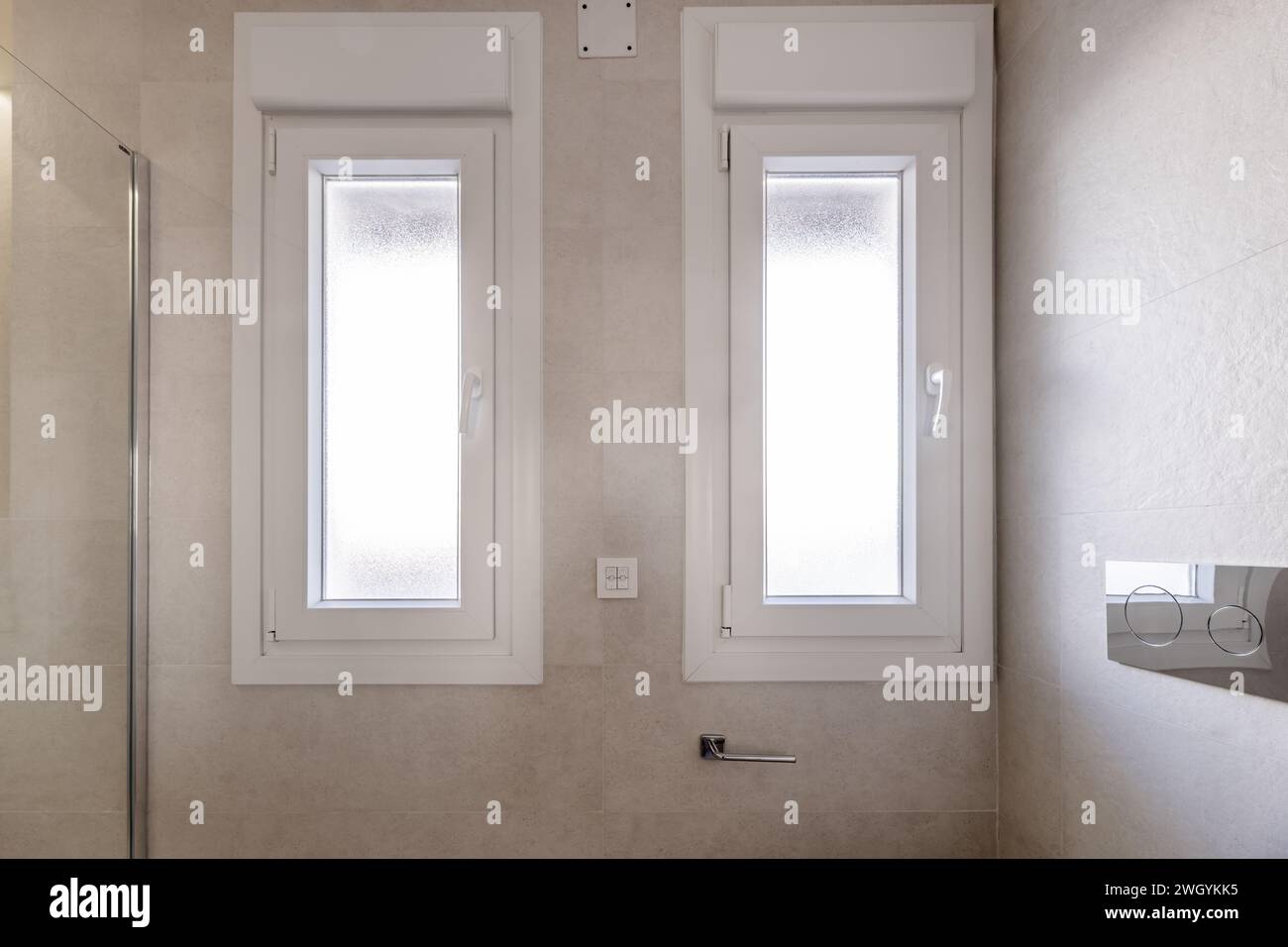 White aluminum double windows in a bathroom next to a shower cabin ...