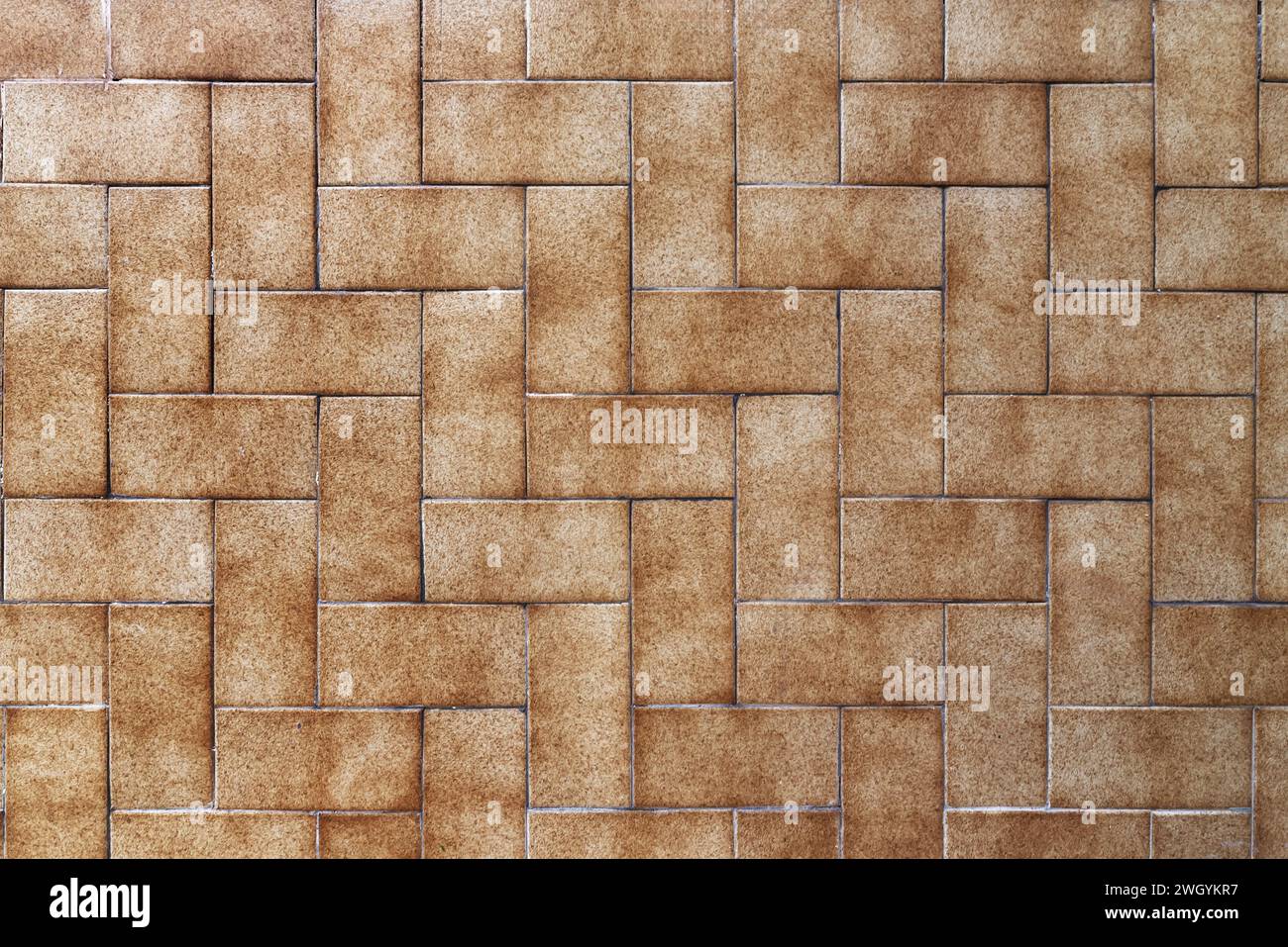 A wall covered in small rectangular brown tiles. Vector tile texture ...