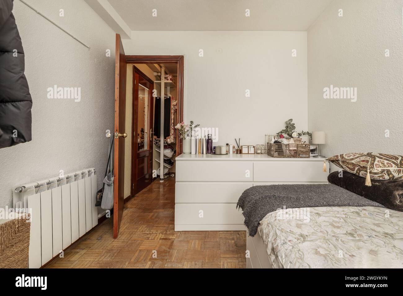 A youth bedroom with a single bed, aluminum radiator and a white ...