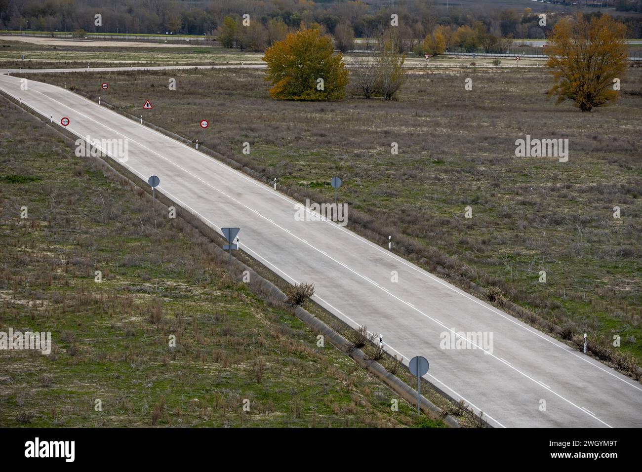 An empty road with one lane in each direction circulating in a low ...