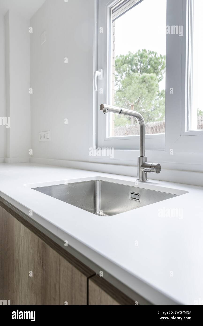 Kitchen faucet with stainless steel bowl embedded in the countertop ...