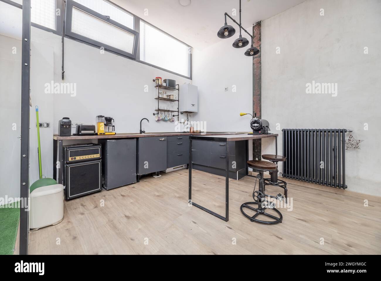 Small kitchen with gray furniture in a loft-style home with high ...