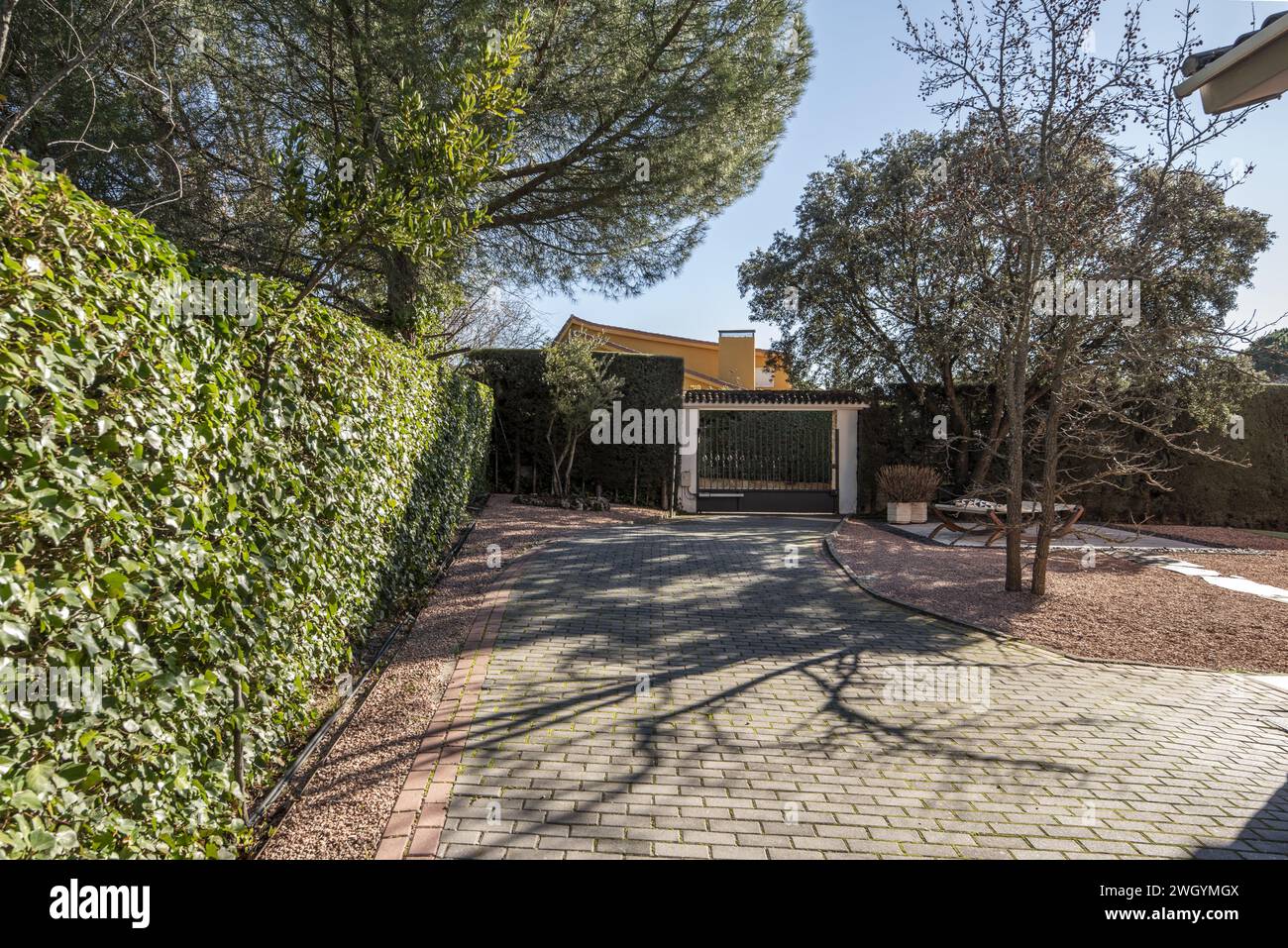Access walk to a garage within a plot of a house with the ground ...