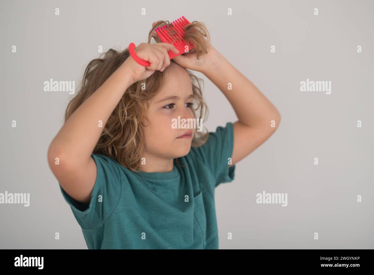 Funny hairstyle. Kids hair care concept. Portrait of kid brushing her ...