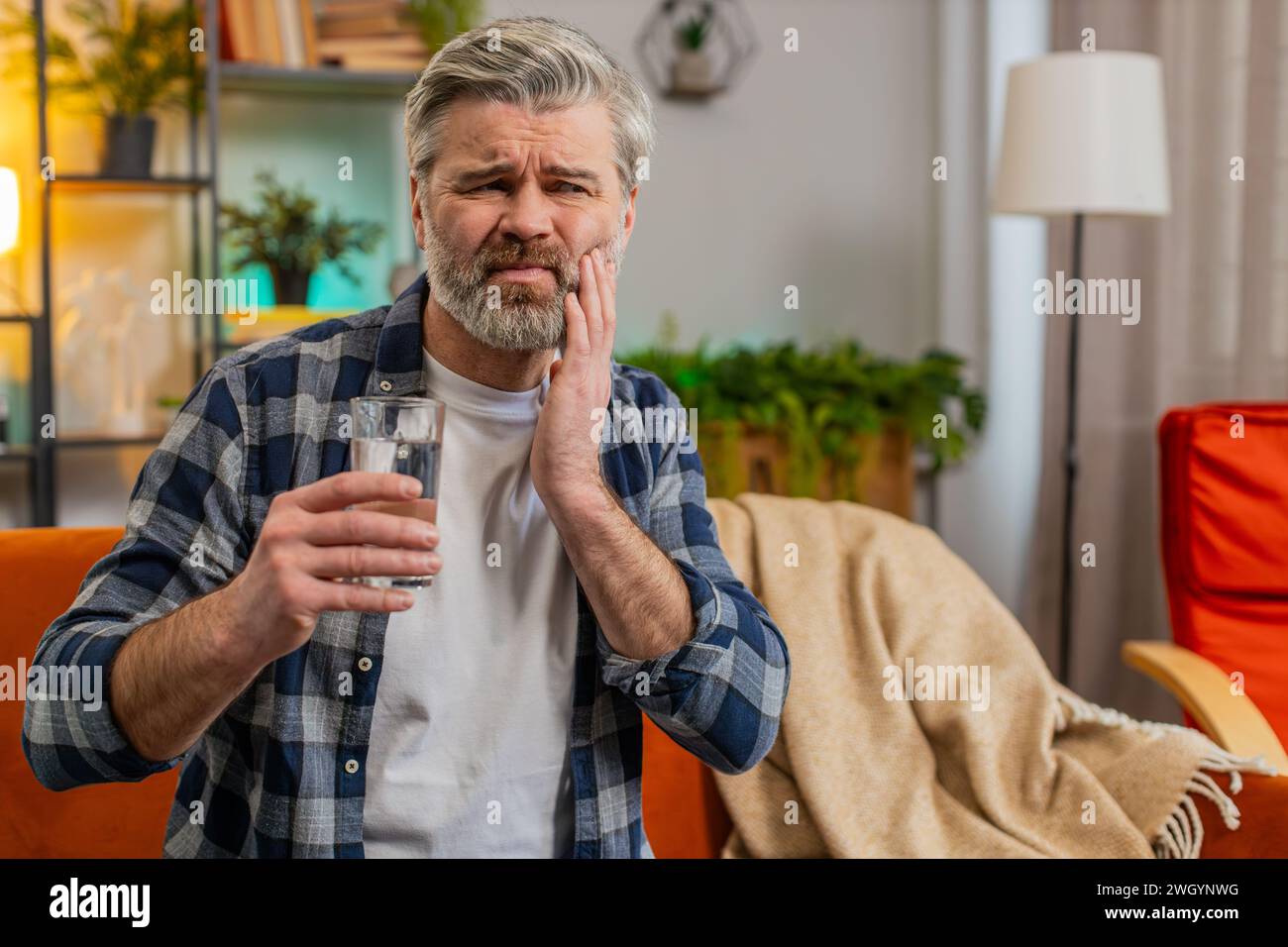 Senior man feel terrible toothache after drink cold water. Middle-aged ...