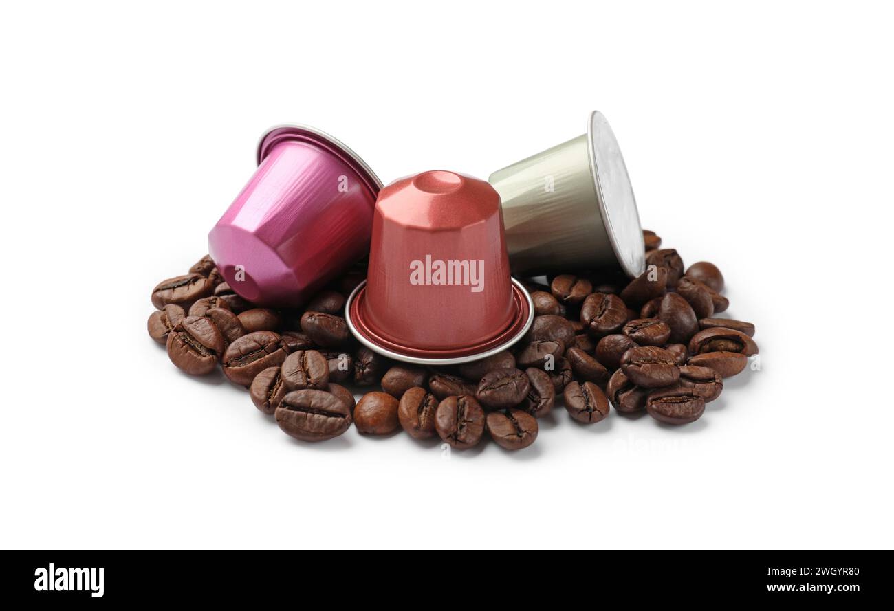 Many coffee capsules and beans isolated on white Stock Photo - Alamy