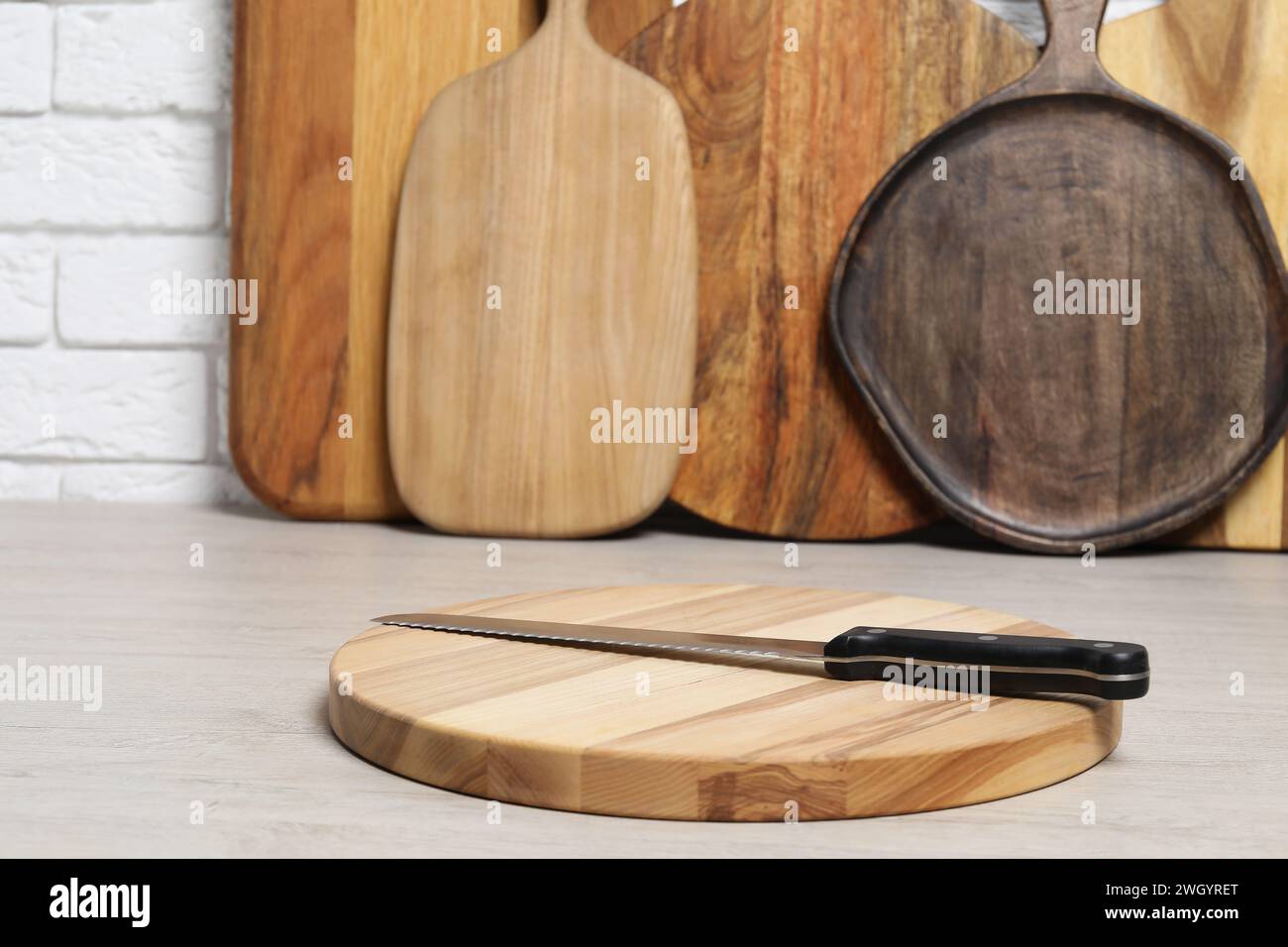 Different cutting boards and knife on light table Stock Photo - Alamy