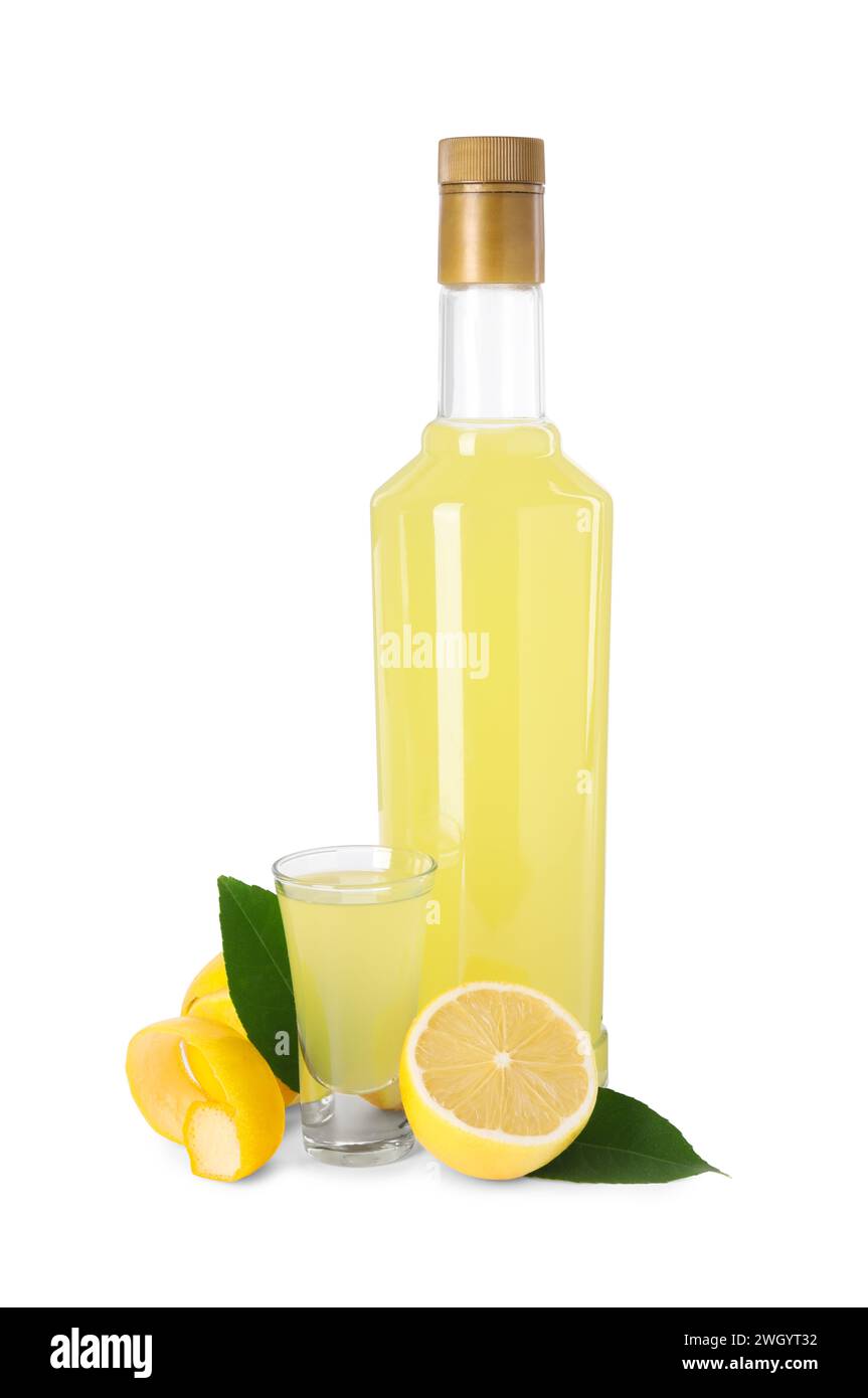 Tasty limoncello liqueur, lemons and green leaves isolated on white ...