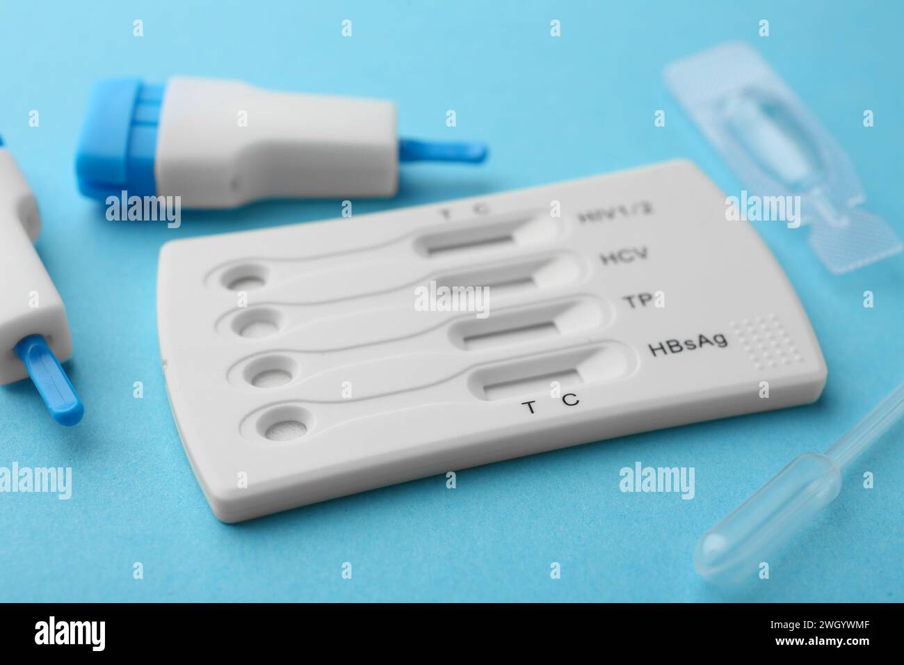 Disposable multi-infection express test kit on light blue background ...