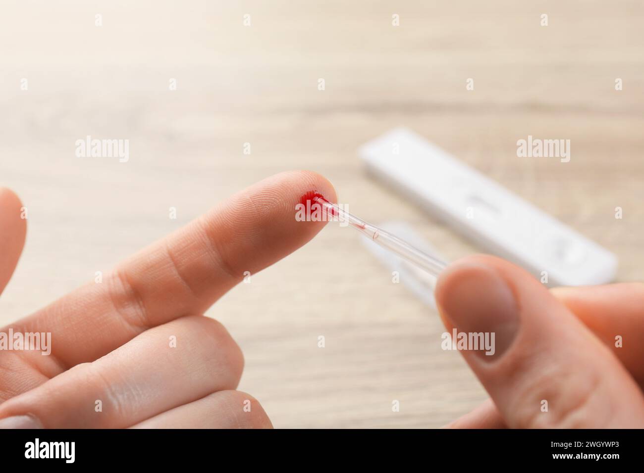 Laboratory testing. Woman taking blood sample from finger with pipette ...