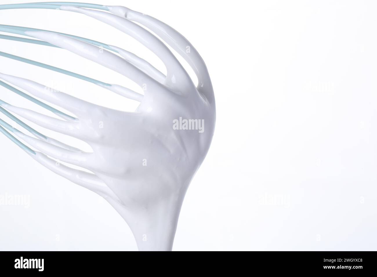 Whisk with whipped cream isolated on white Stock Photo - Alamy