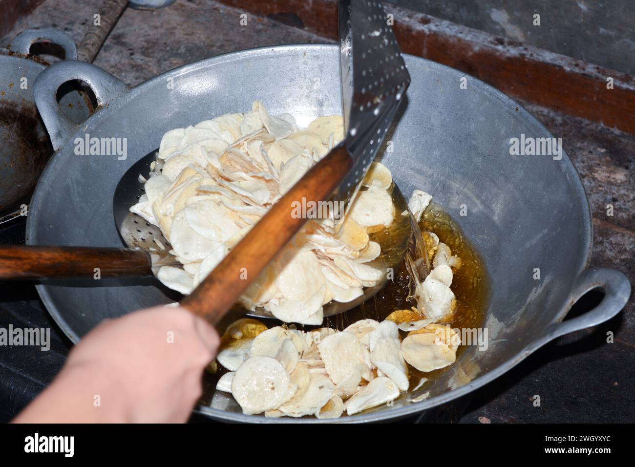 A woman who is frying cracker snacks Stock Photo - Alamy