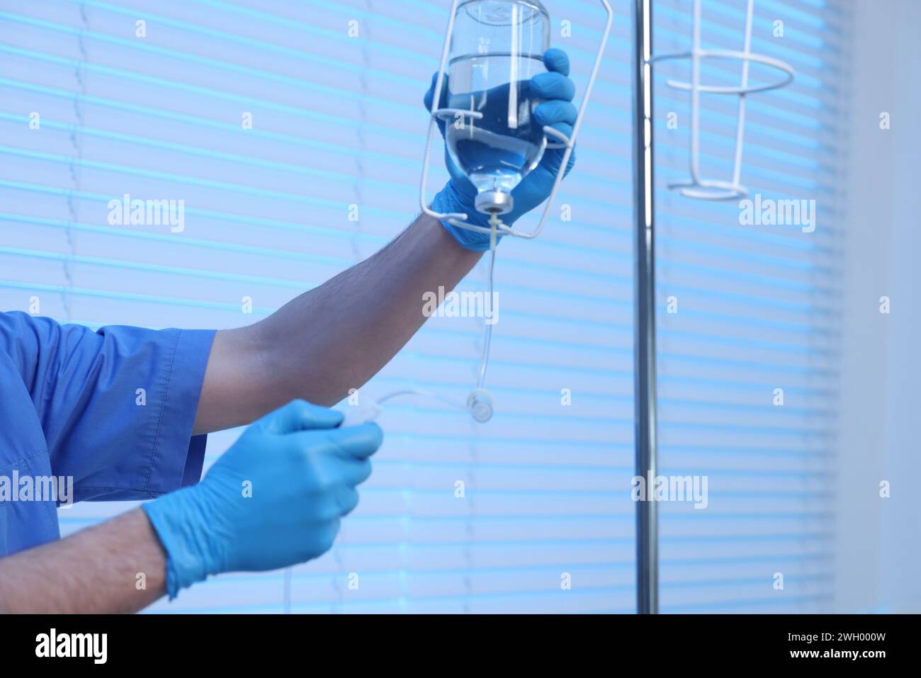 Nurse setting up IV drip in hospital, closeup. Space for text Stock ...