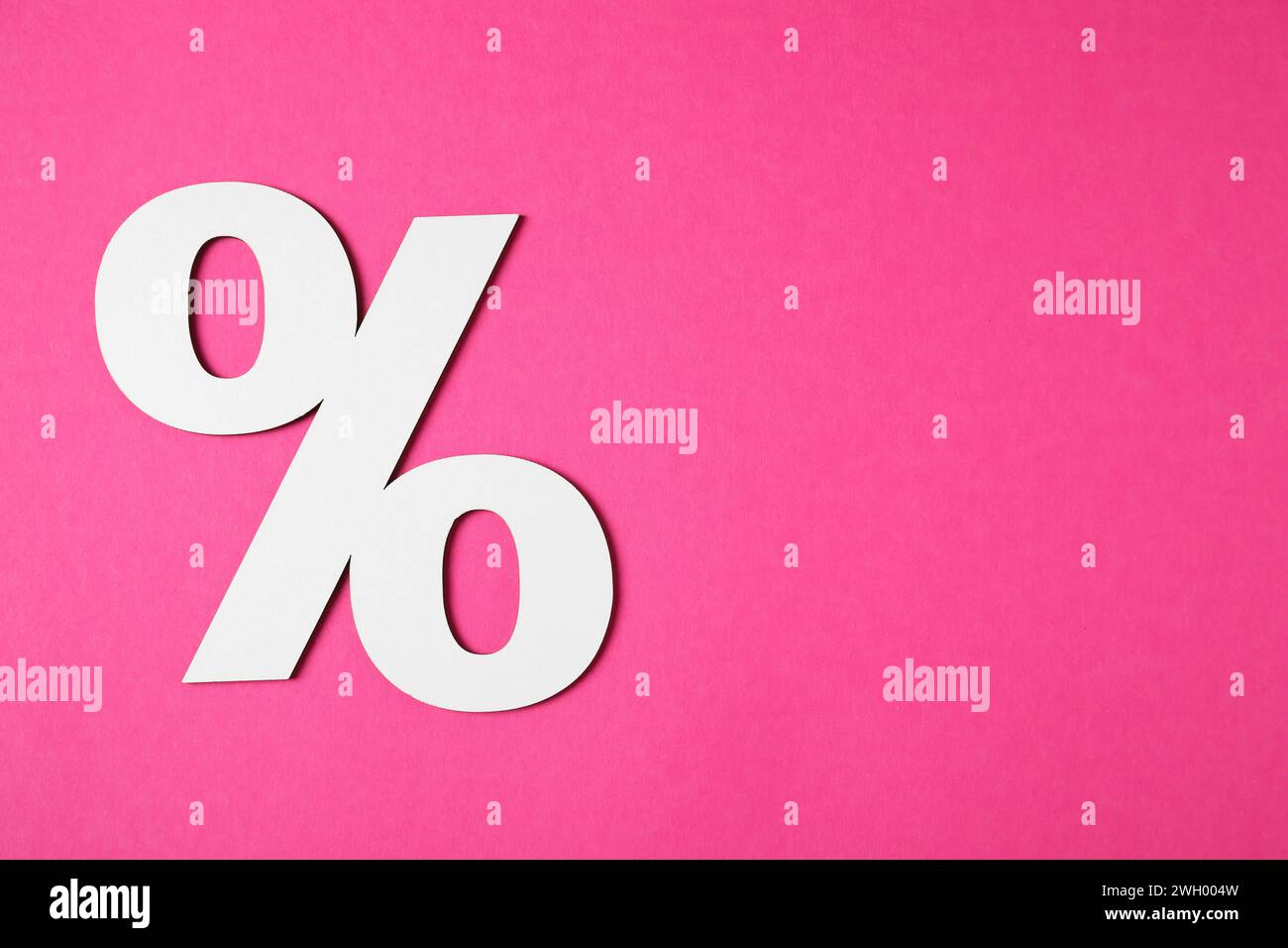 White percent sign on pink background, top view. Space for text Stock ...
