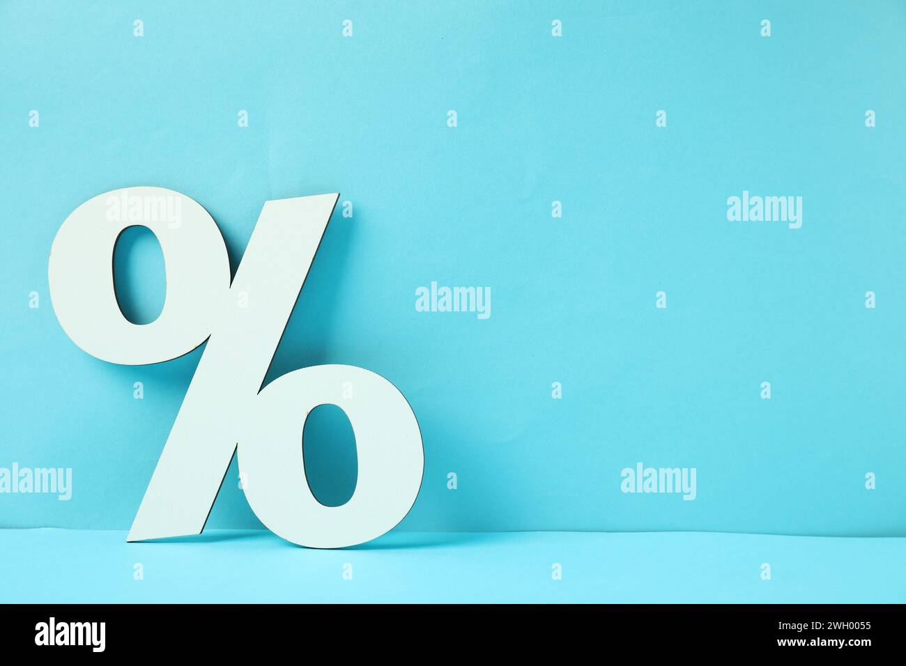 White percent sign on light blue background. Space for text Stock Photo ...