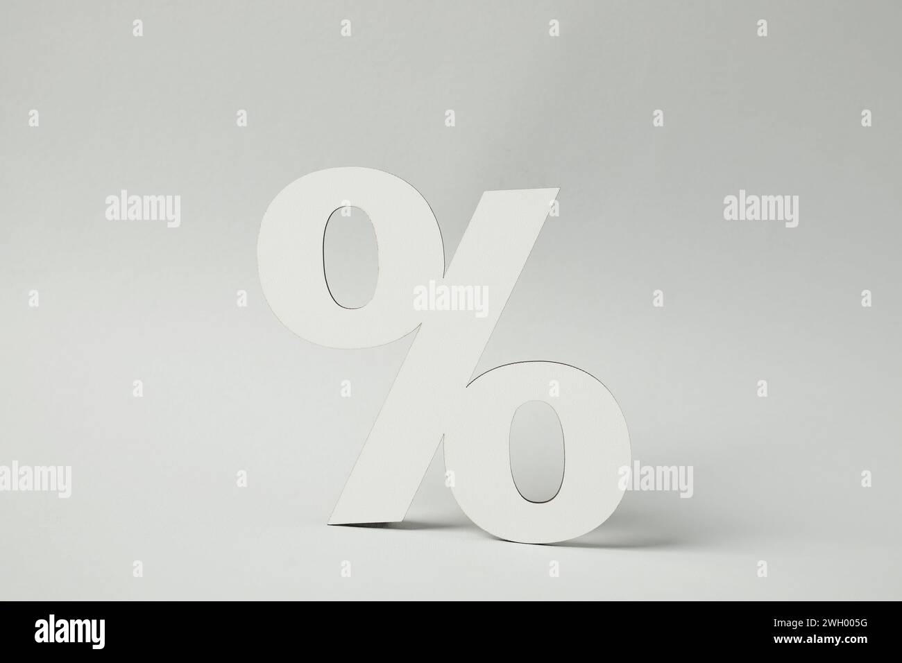 White percent sign on light grey background Stock Photo - Alamy