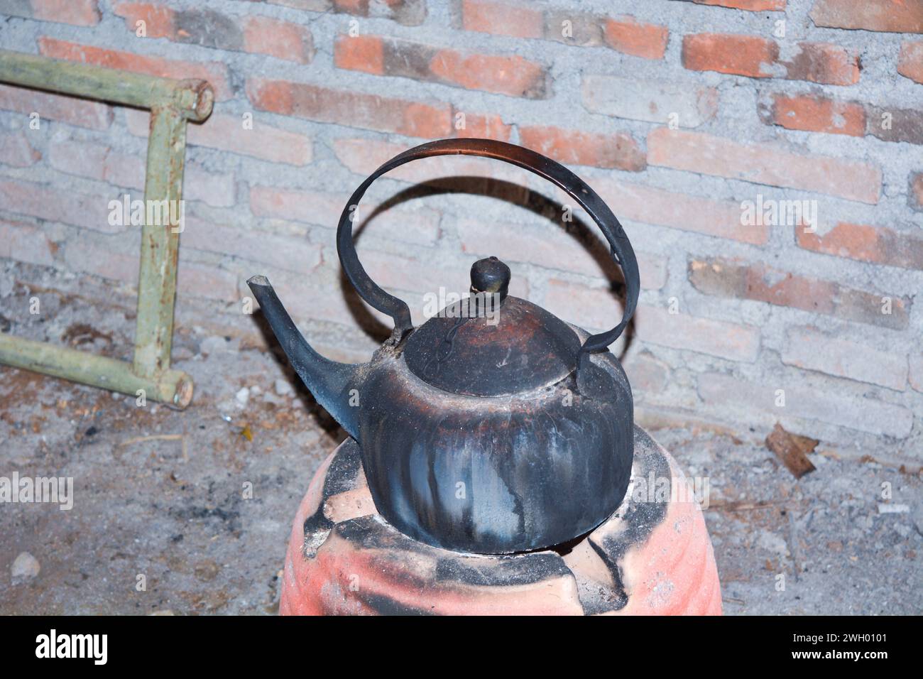 Still life typical Indonesian traditional teapot. Against a red brick ...