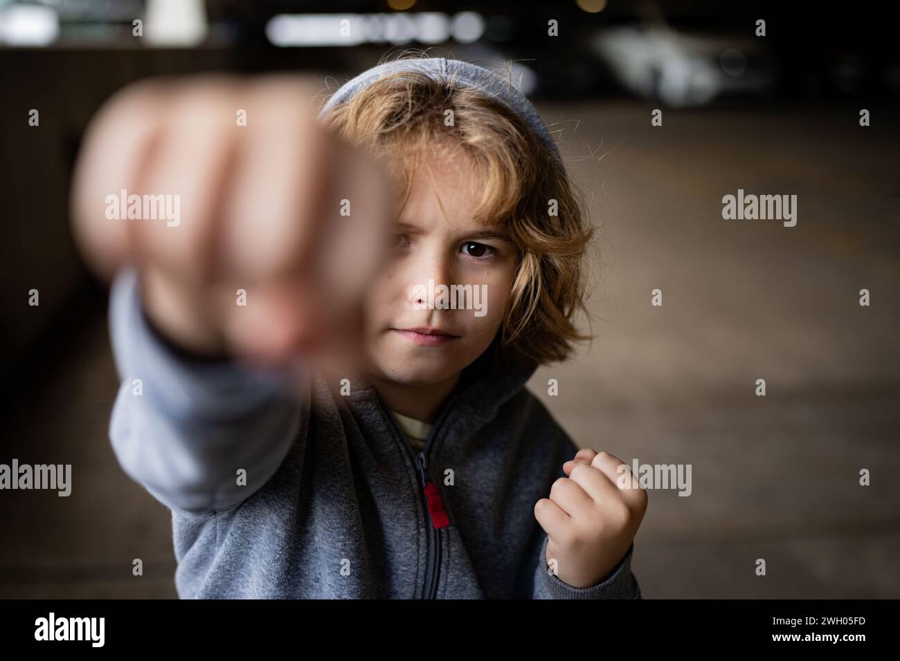 Kid boy in hoodie fighting. Little kid boy fighting outside. Angry ...