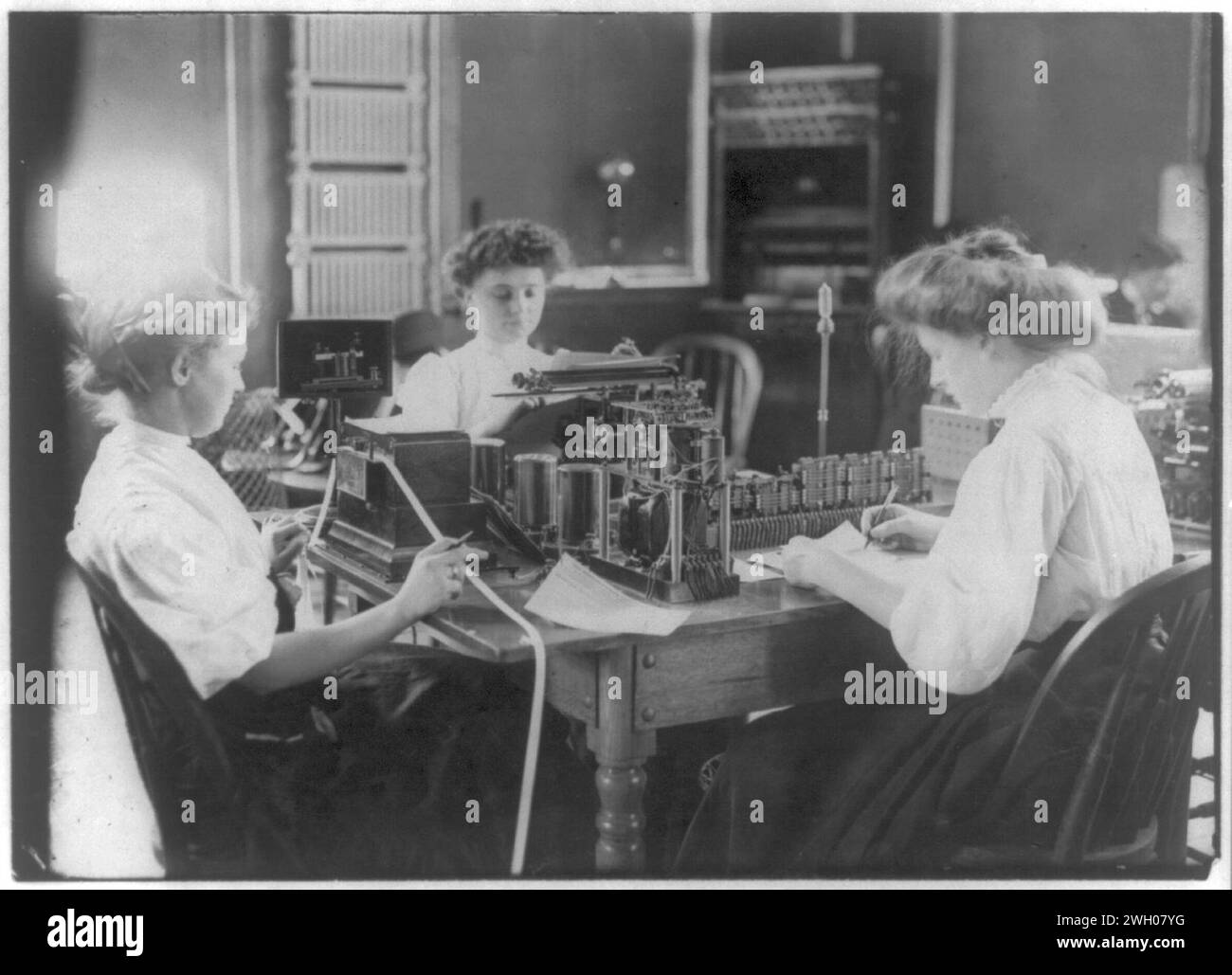 Barclay telegraph instruments. Showing instruments on stand with women ...