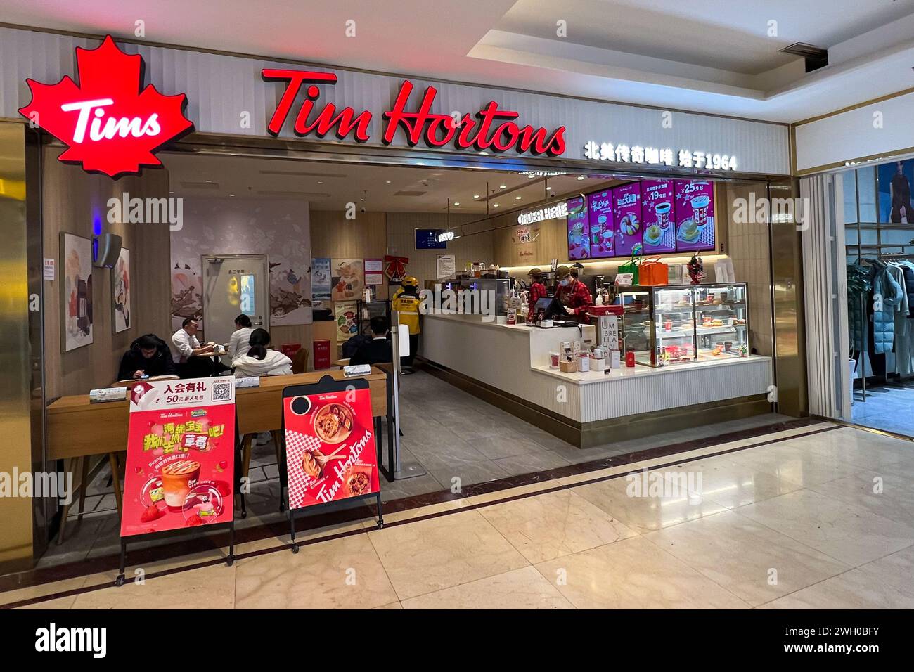Beijing, China. 08th Dec, 2023. Customers enter a Tim Hortons store in ...