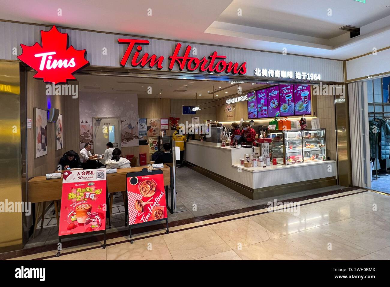 Beijing, China. 08th Dec, 2023. Customers enter a Tim Hortons store in ...