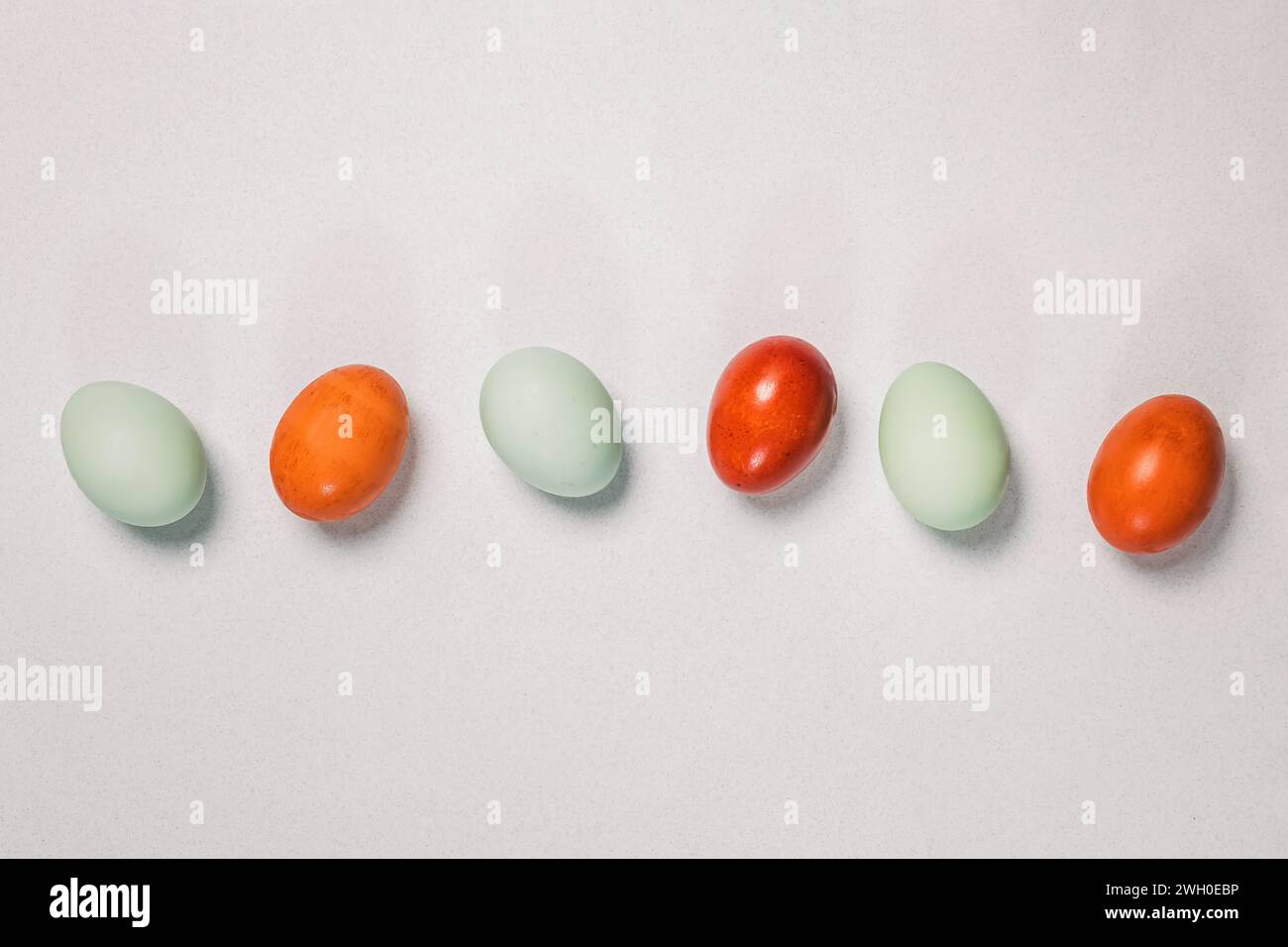 Row of naturally colored eggs, blue and red, natural farming, easter ...