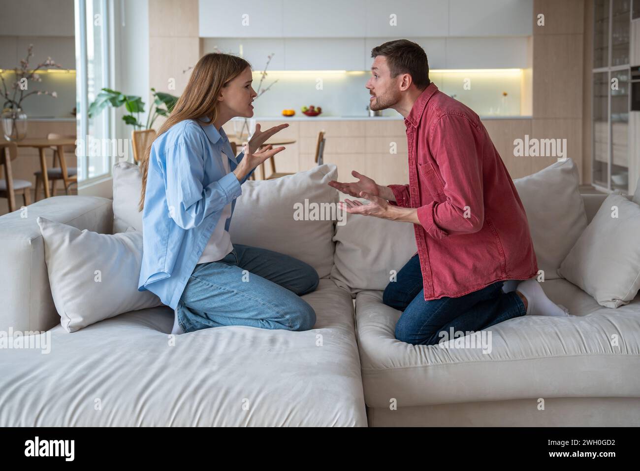 Angry abusive husband and hysterical wife quarrelling at home, shouting ...