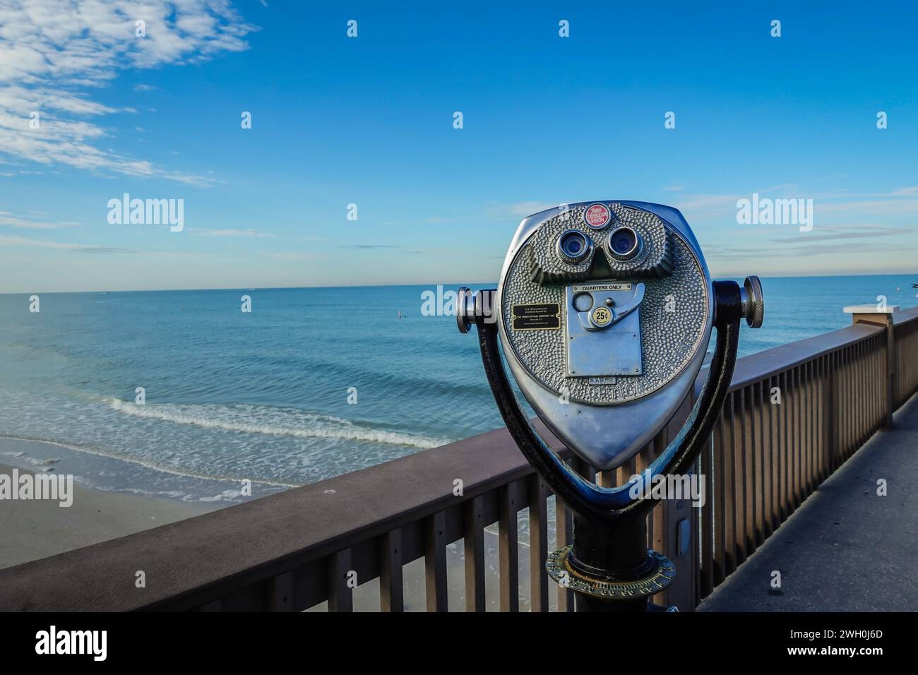 Coin-operated binocular viewer overlooking serene beach and ocean in ...