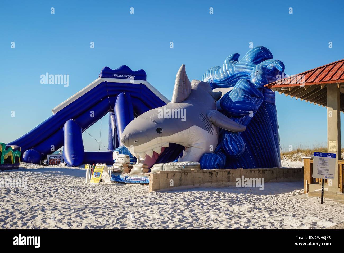Shark-shaped bouncy castle on a white sandy beach, outdoor fun Stock ...