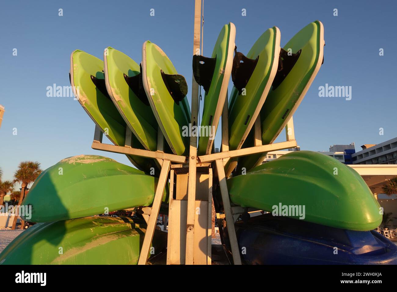 Stack of green kayaks and paddleboard together on a beach Stock Photo ...