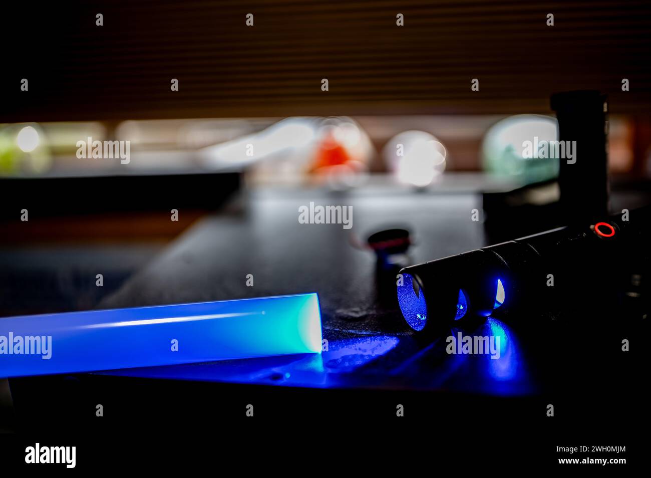 Assorted parts to build a laser sword from a kit with a hilt, neon ...