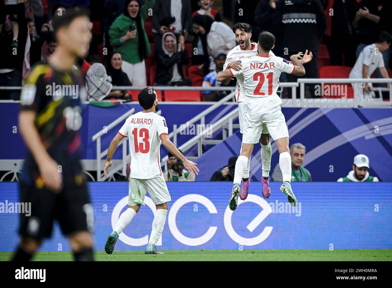 Al Rayyan, Qatar. 6th Feb, 2024. Jordan's Yazan Alnaimat (top) shoots ...