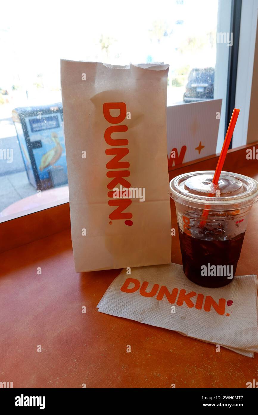 Dunkin' Donuts paper bag and iced coffee inside the shop Stock Photo ...