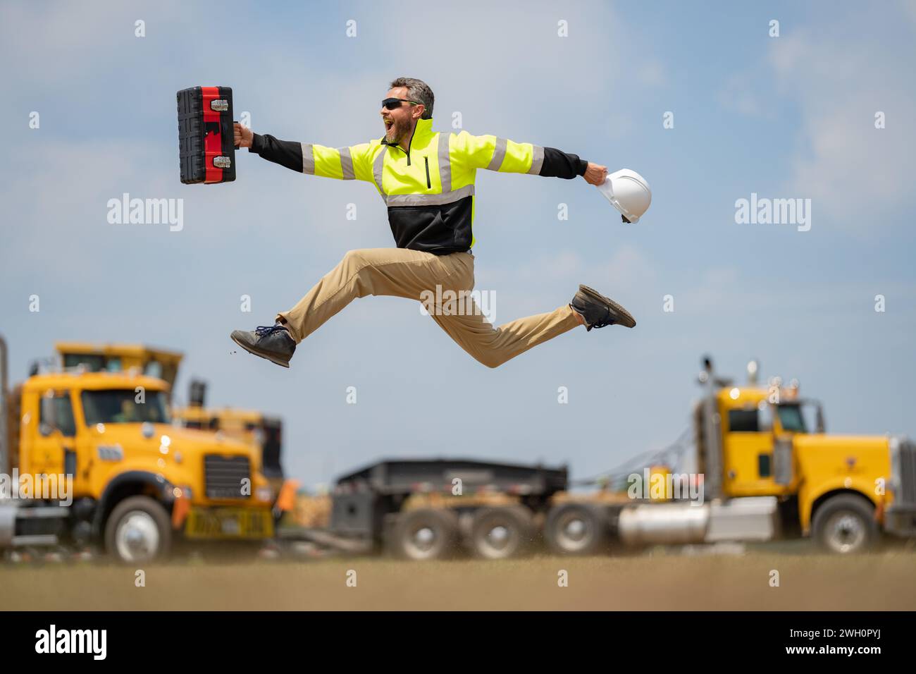 Hispanic builder excited jump and run on site construction. Excited ...