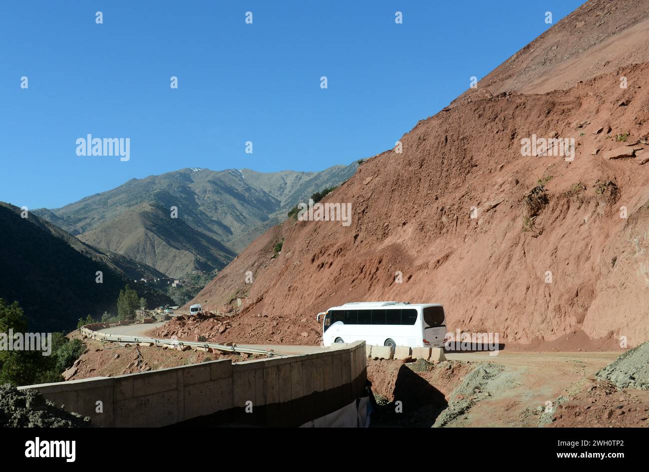 A bus traveling down the road in the Atlas mountains in Morocco Stock ...